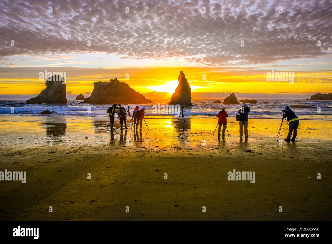 Group of photographers taking photos of the rock formations and sun ...