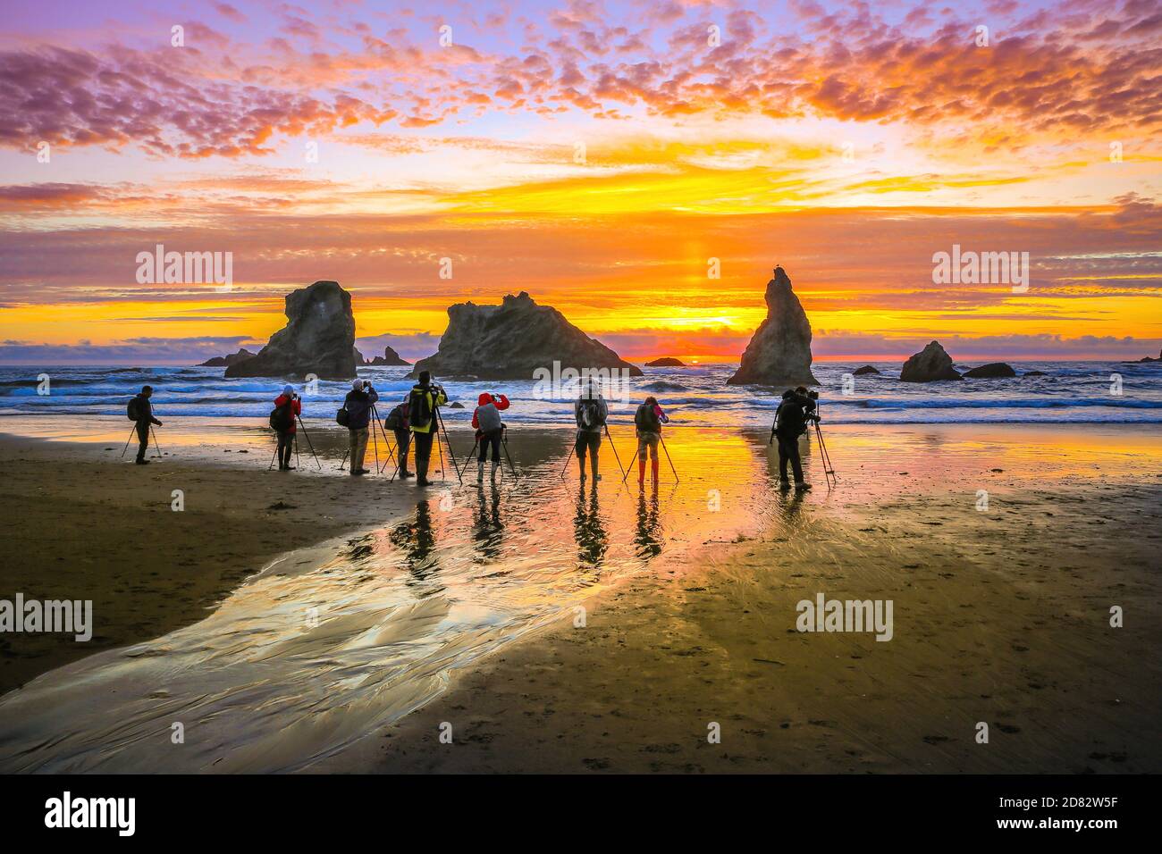 Group of photographers taking photos of the rock formations and sun ...