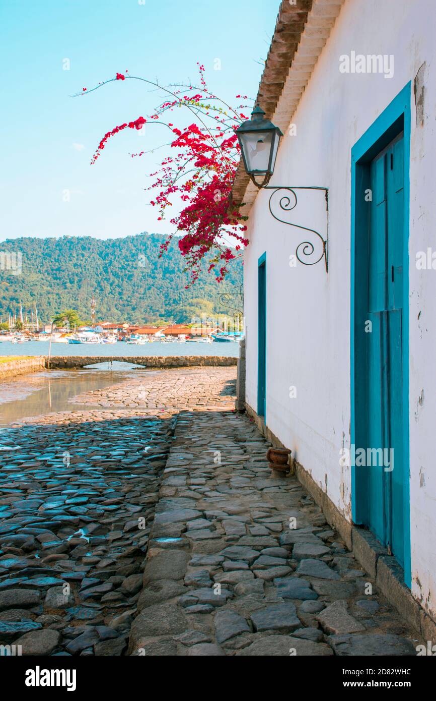 A white building with blue details by the sea Stock Photo - Alamy