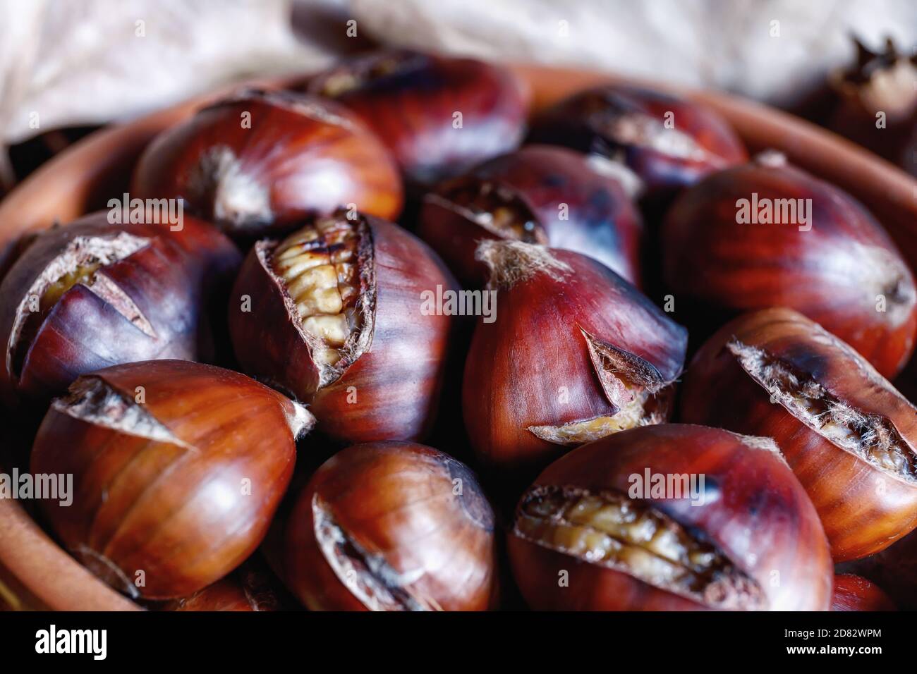 Roasted chestnuts in the plate ready to eat. closeup Stock Photo - Alamy