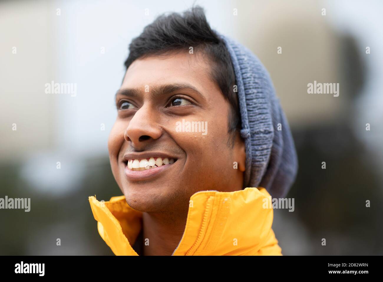 young man with cap and yellow jacket Stock Photo - Alamy