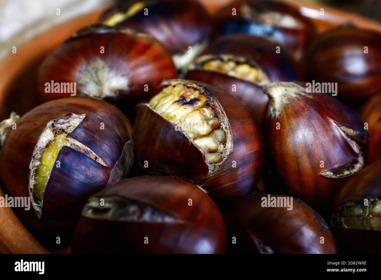 Roasted chestnuts in the plate ready to eat. closeup Stock Photo - Alamy
