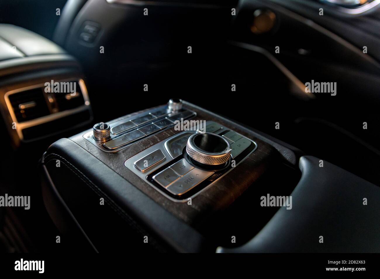 Modern luxury car central console for rear passengers Stock Photo - Alamy