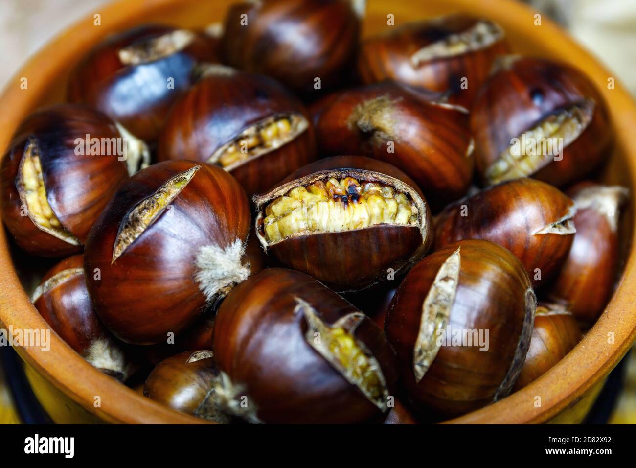 Roasted chestnuts in the plate ready to eat. closeup Stock Photo - Alamy