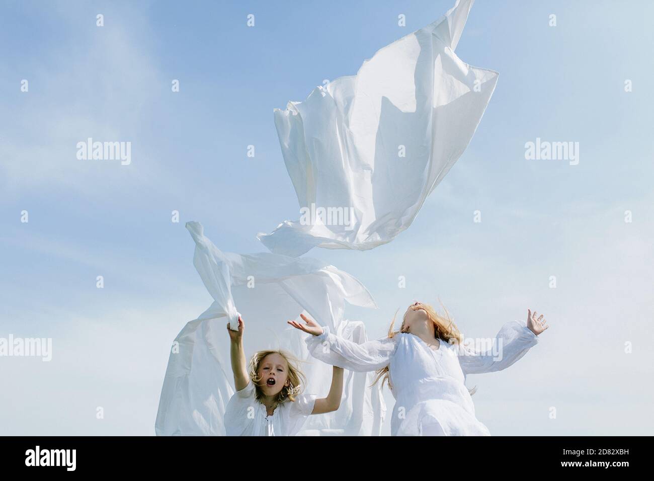 children throw washed sheets into the sky Stock Photo - Alamy