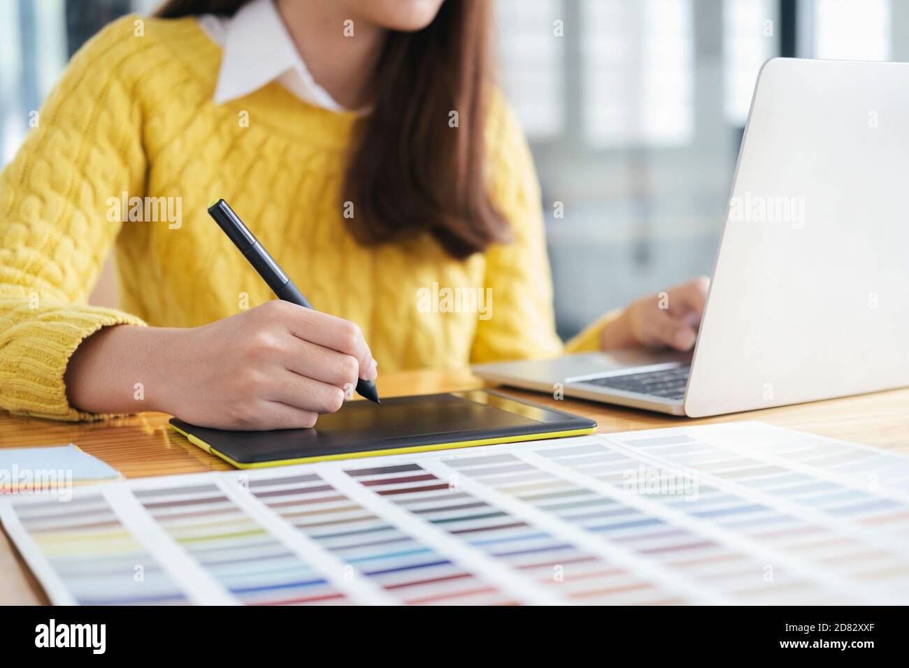 Graphic designer working with color samples for selection. Graphic ...