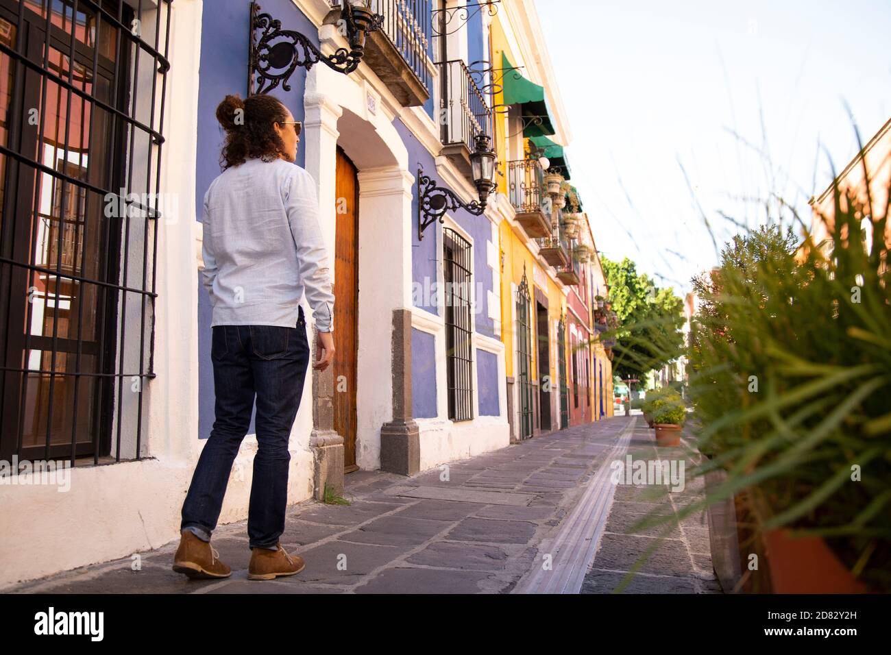 Man walking on Colorful colonial street of Puebla, Mexico Stock Photo ...