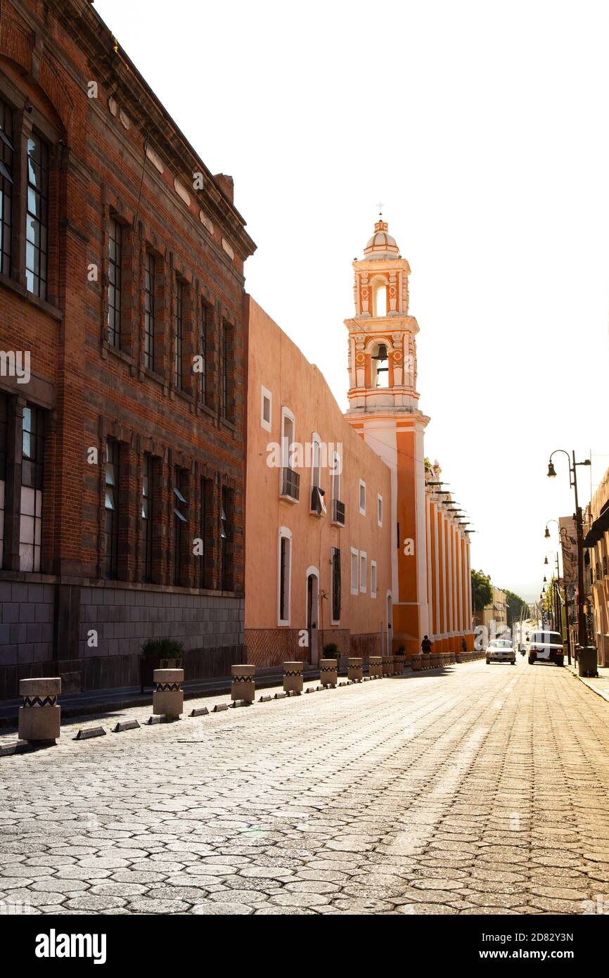 Colonial buildings and Church tower of a street of downtown Puebla ...