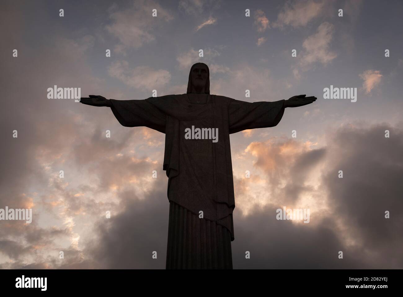 Beautiful view to Christ the Redeemer Statue under sunset clouds ...