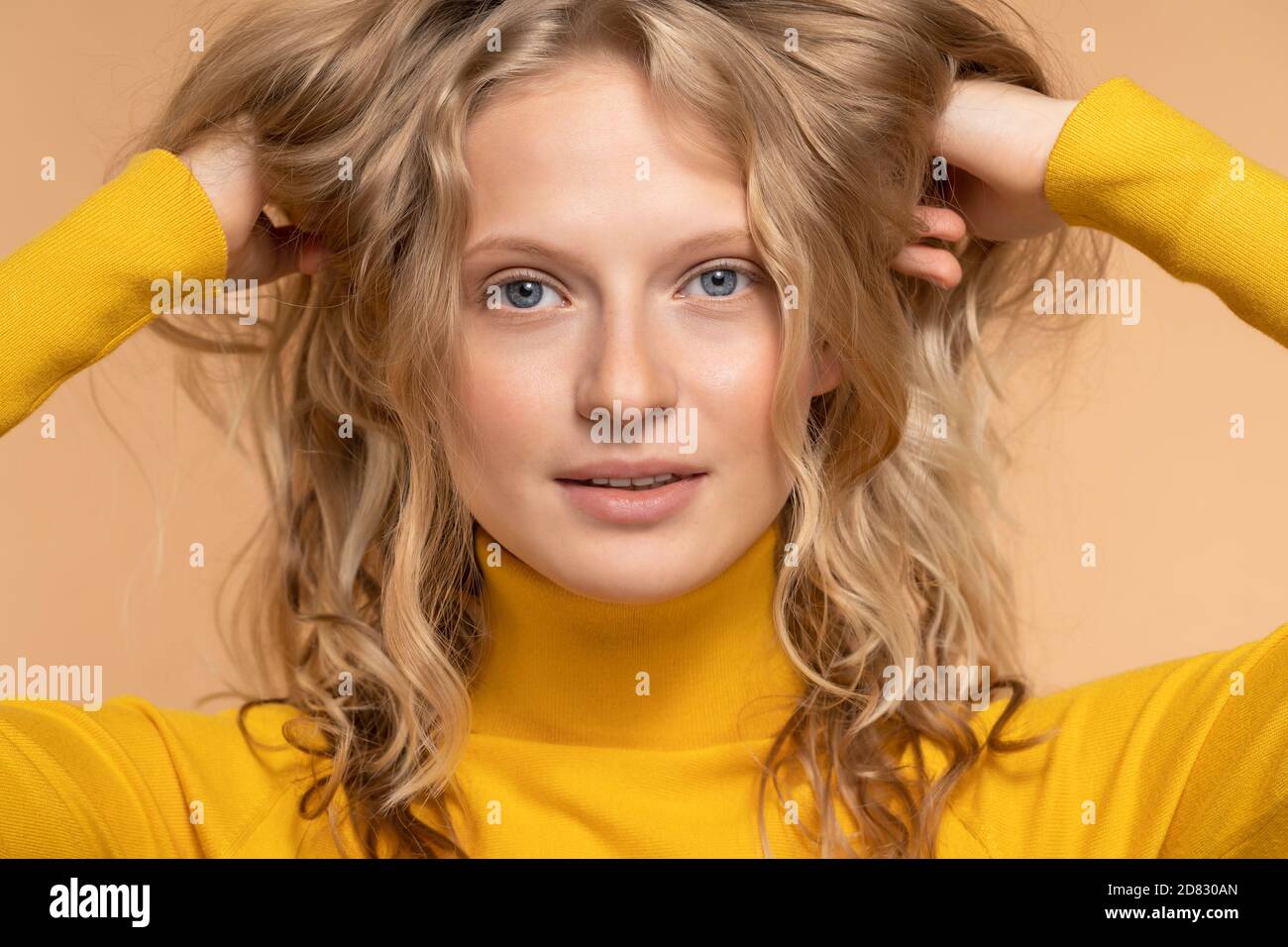 Closeup of young blonde woman with fresh skin, touching her natural ...