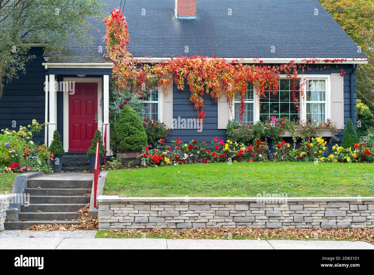 A bright red metal handrail leading up four concrete steps to a walkway ...