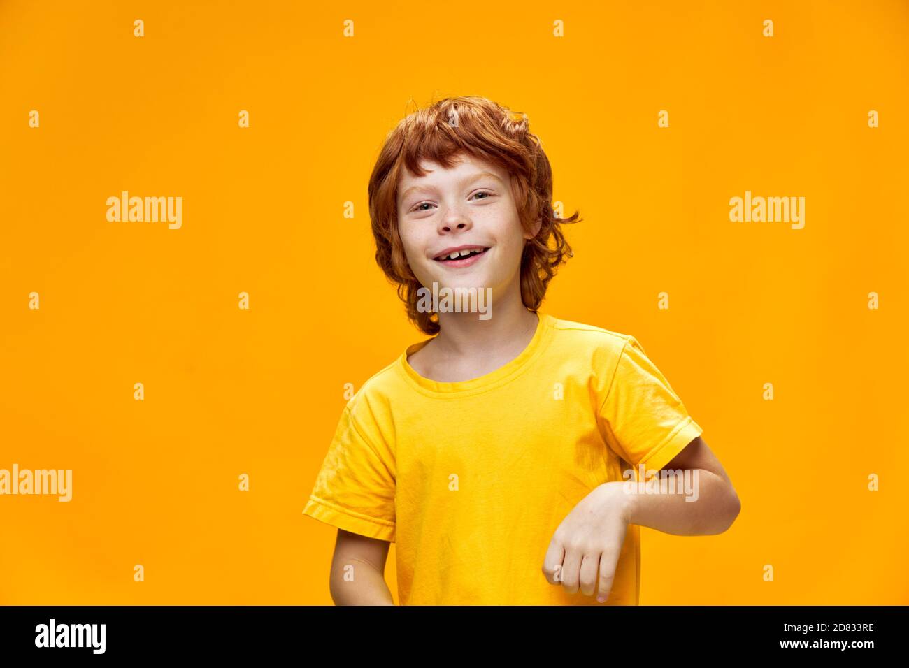 funny redhead boy smiling and looking ahead on isolated background ...