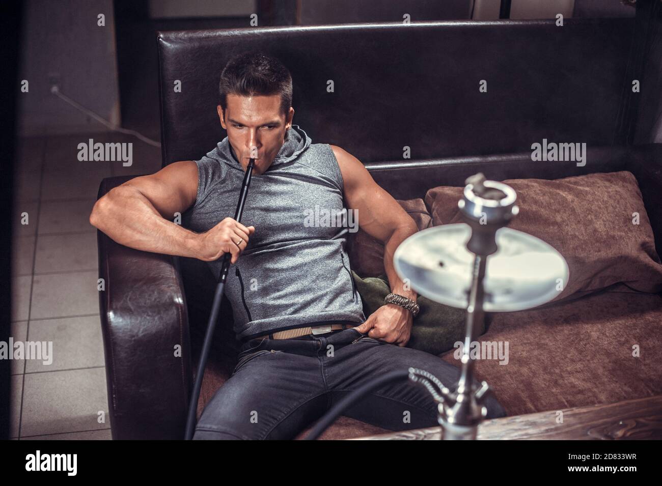 Young man relaxes in a hookah in the hookah bar Stock Photo - Alamy