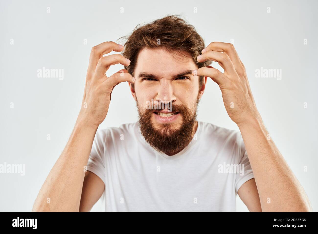 Bearded man gesturing with hands cropped view white t-shirt studio ...