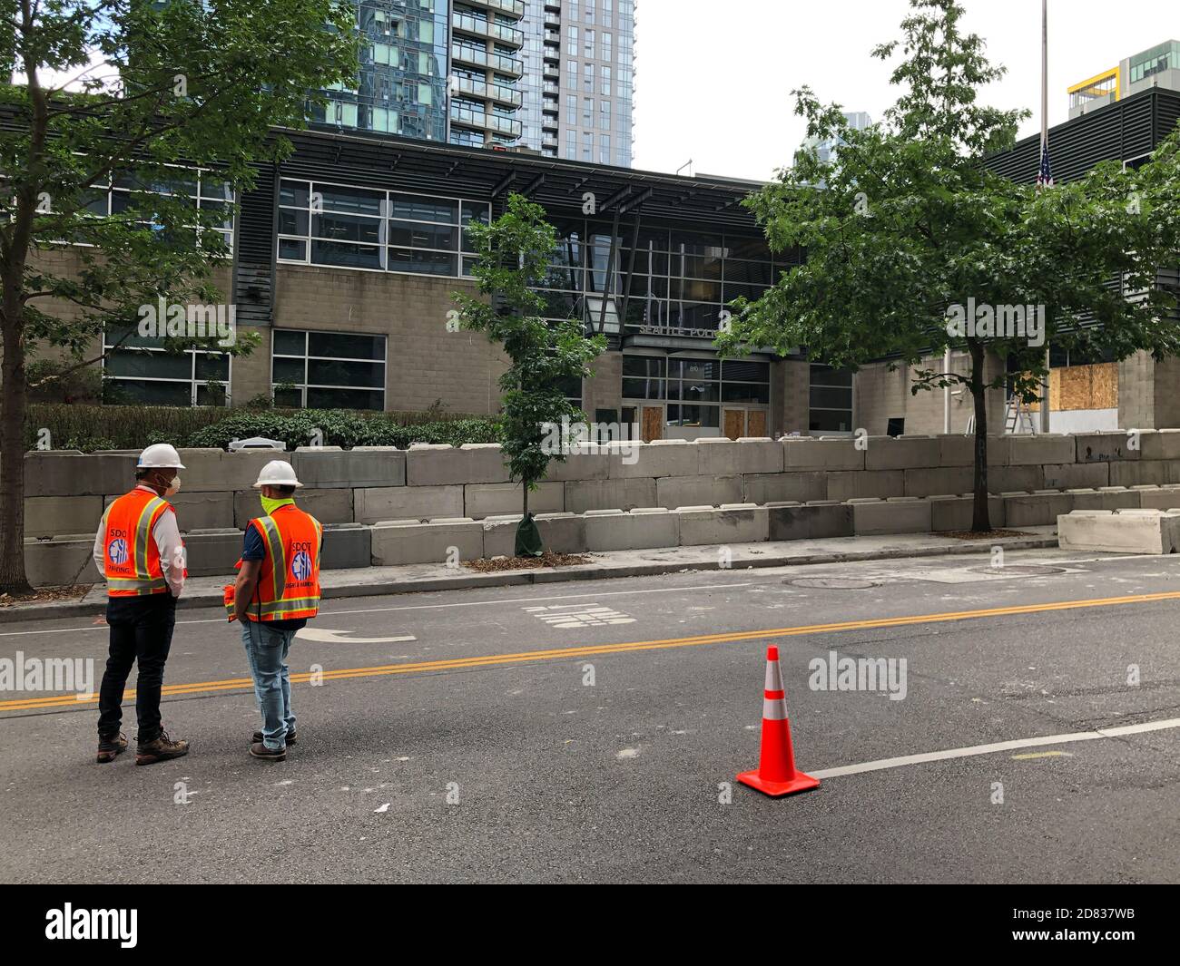 Seattle, USA Jun 23, 2020: Workers installing a wall at the West ...