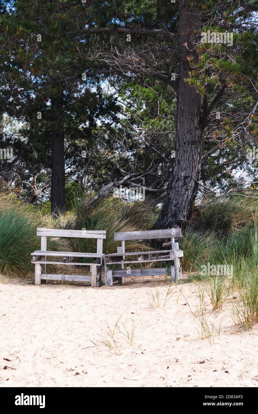 couple of simple benches made of upcycled wooden pallets on a beach in ...