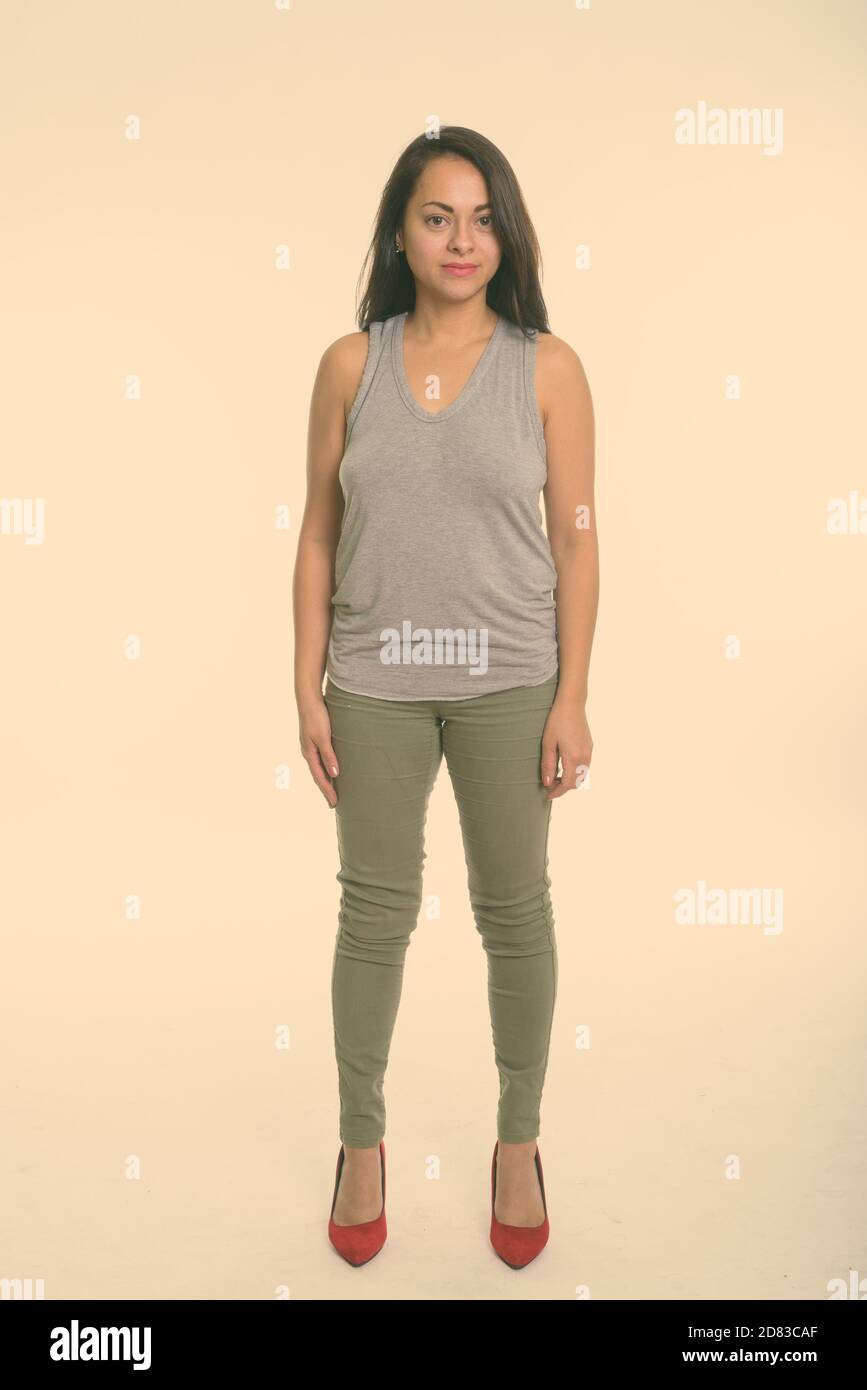 Full body shot of beautiful woman standing against white background ...