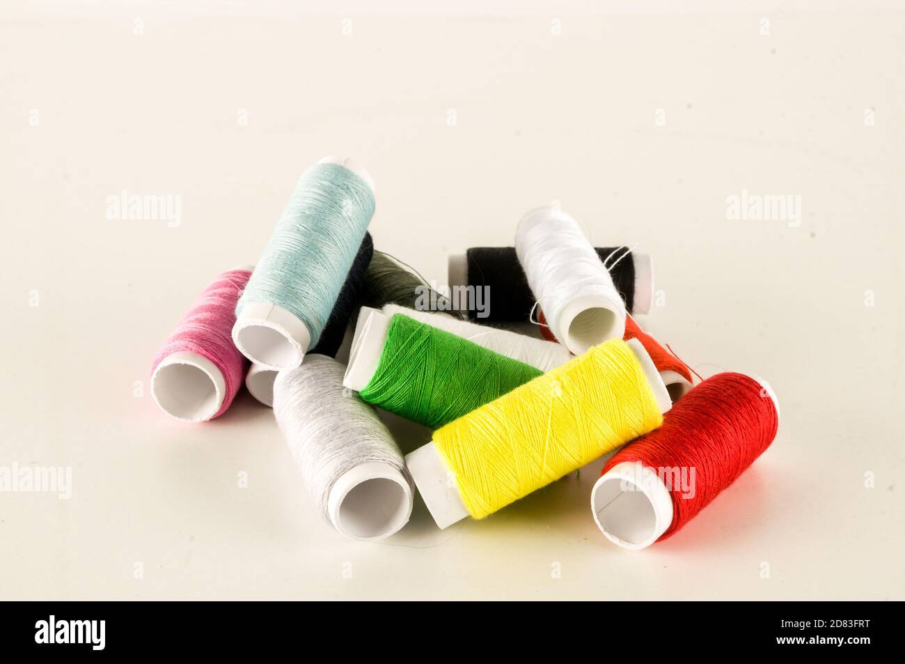 Colored sewing thread background Stock Photo - Alamy