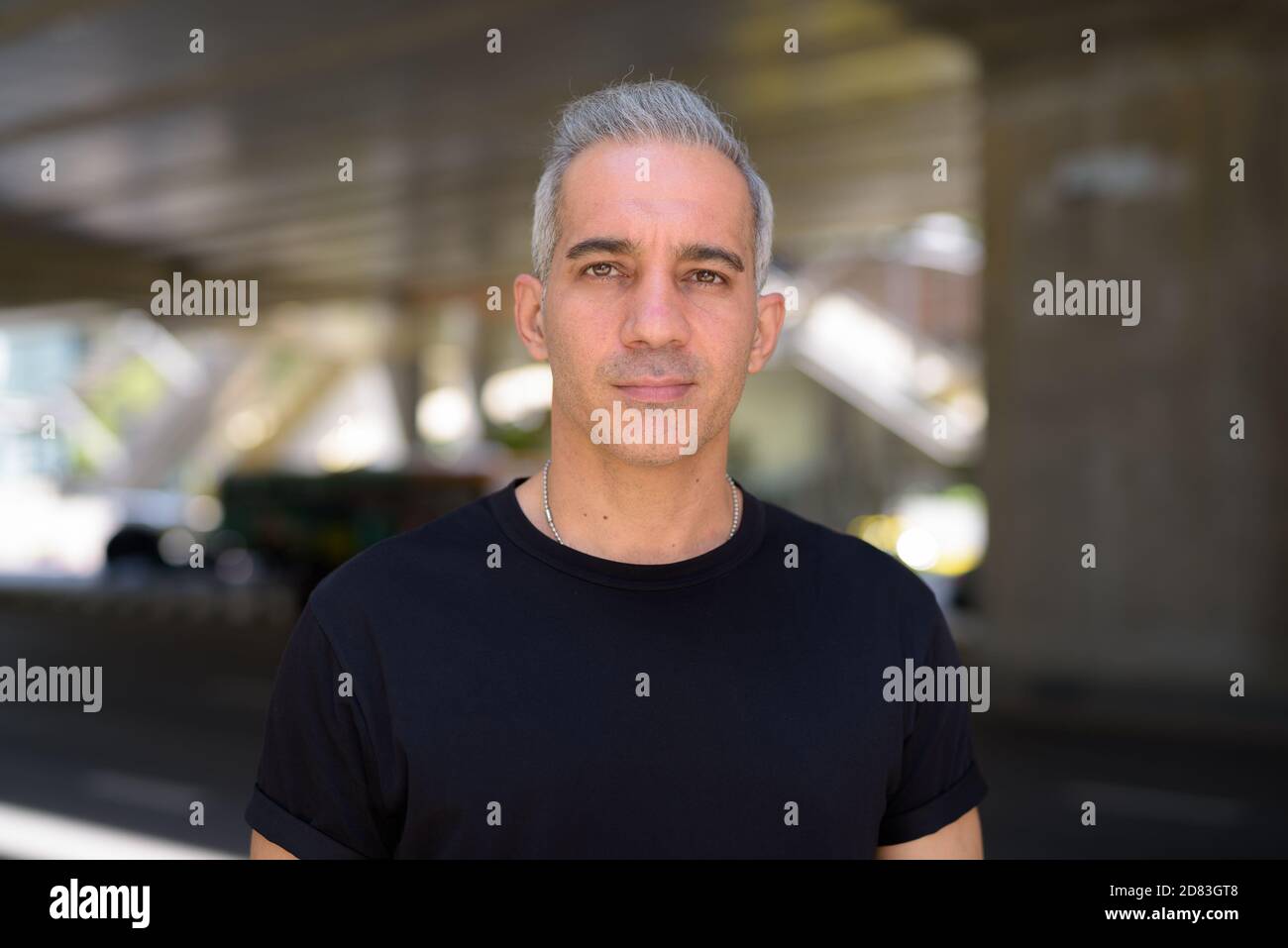 Face of handsome Persian man with gray hair in the city streets ...