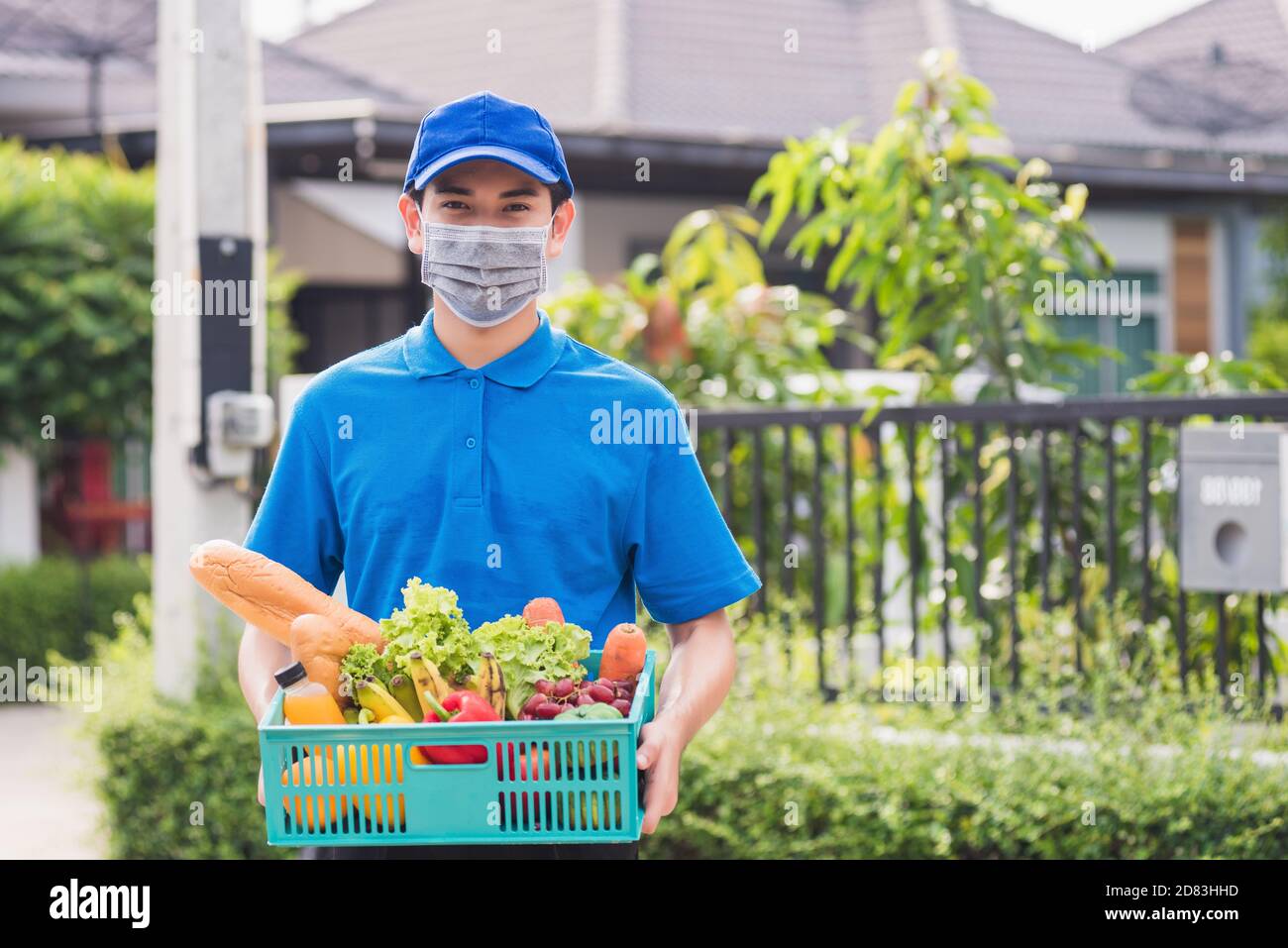 Man holding blue shopping basket hi-res stock photography and images ...