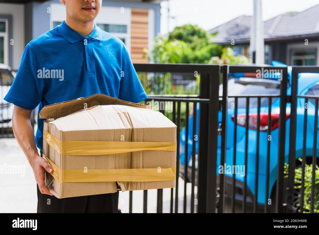 Asian young delivery man in blue uniform he emotional falling courier ...