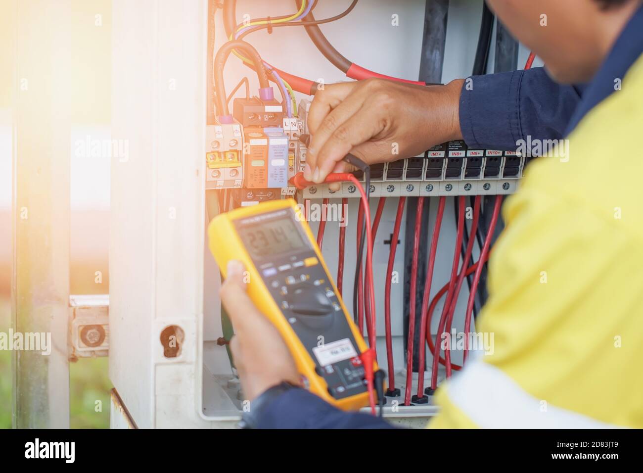 Workers use Multimeter to measure the voltage of electrical wires ...