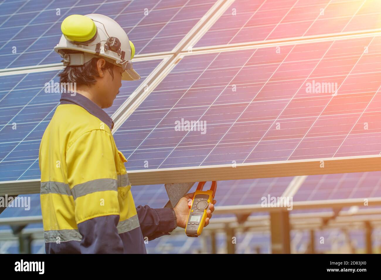 Workers use Clamp meter to measure the current of electrical wires ...