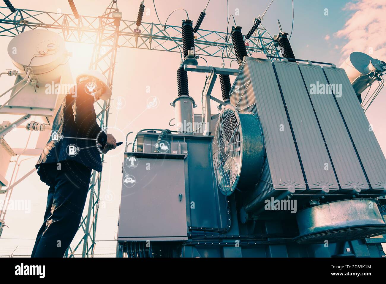 Businessman wearing a black suit, standing looking at a large power ...