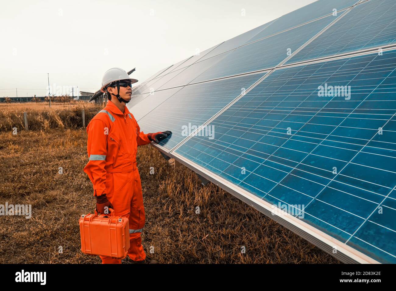Engineers hold a tool for checking the performance of the solar panel ...