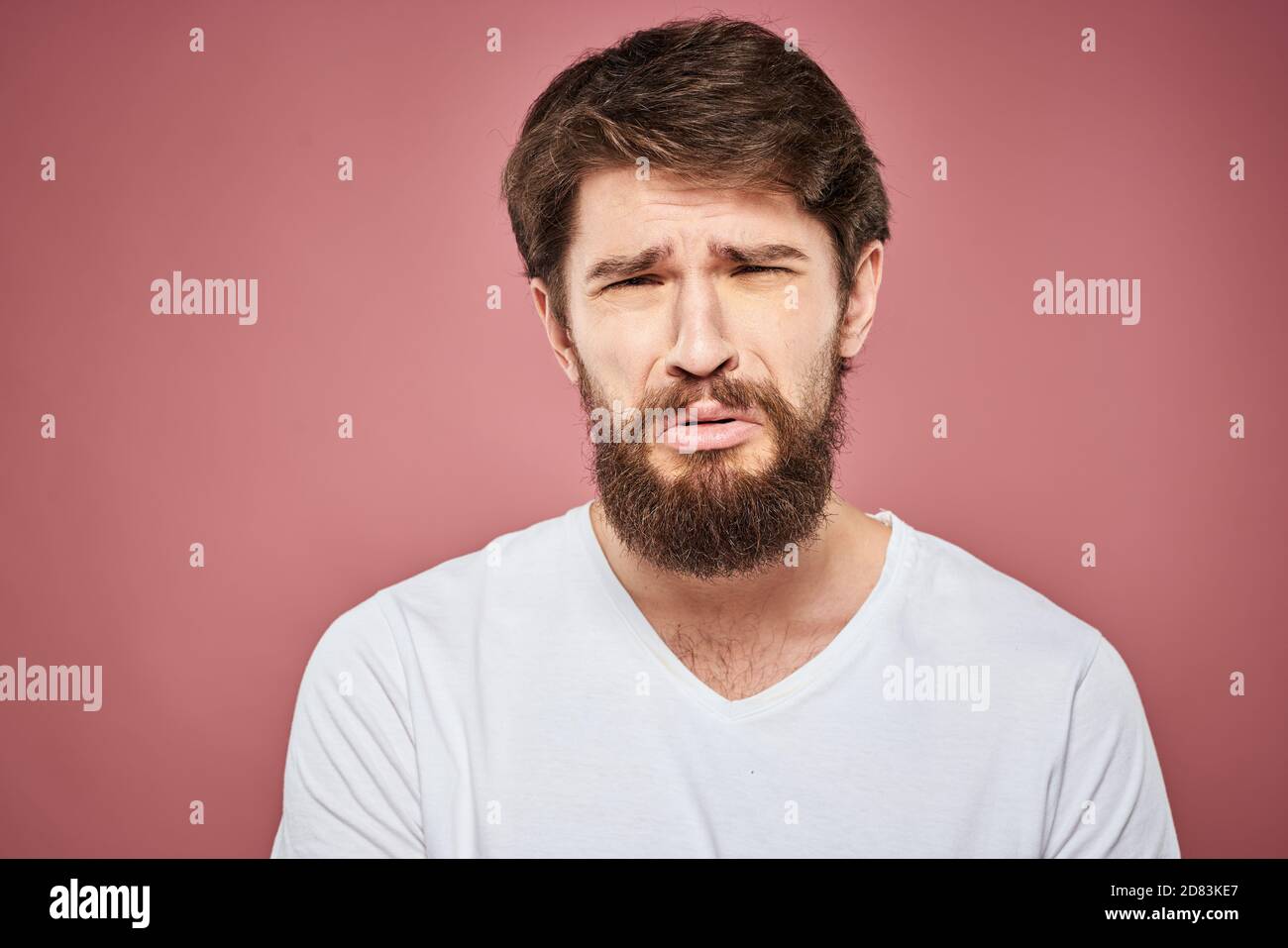 emotional man white t shirt sad facial expression pink background Stock ...