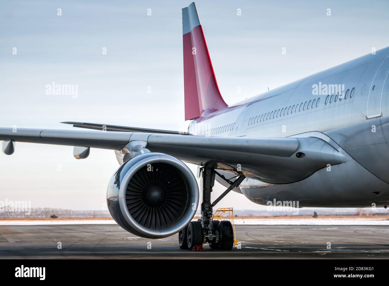 Close-up of wing, engine, main landing gear, fuselage and tail fins of ...