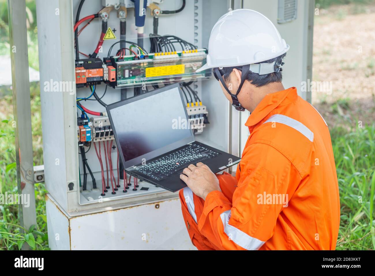 Engineers upload data of power energy to a laptop for checking the ...