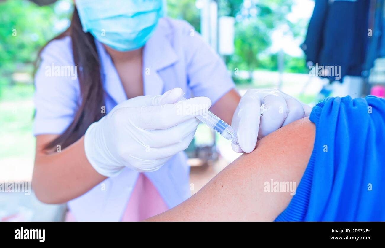 The doctor's hand held a syringe to vaccinate people, And must wear a ...