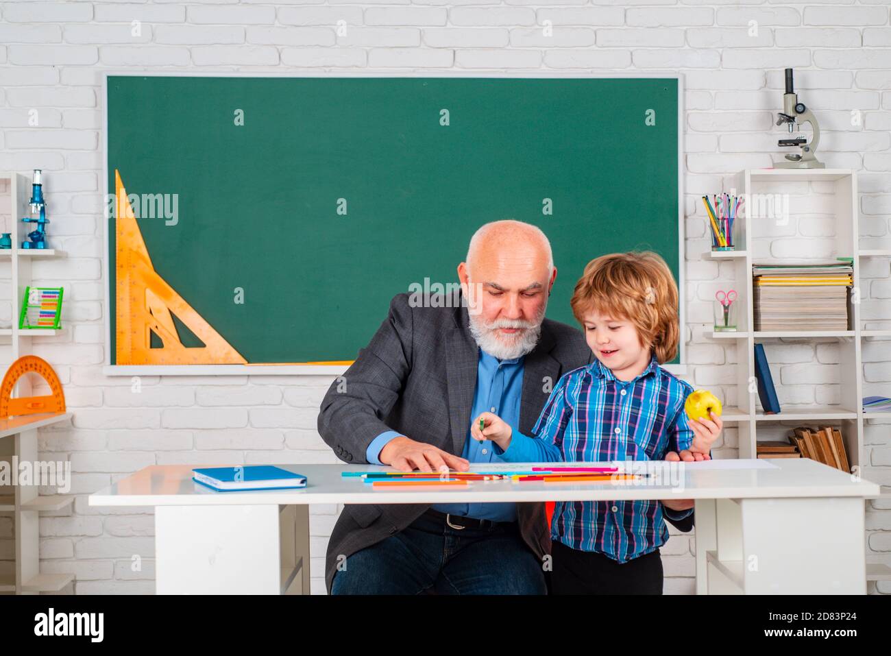 Pupil study at school with old teacher. Professor and pupil in ...