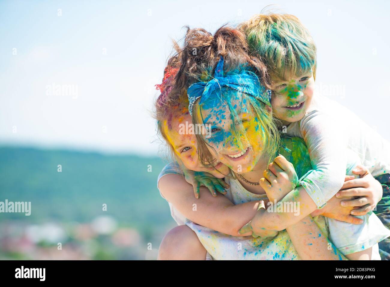 Bright summer colors. Happy kids smiling laughing and hugging outdoors ...