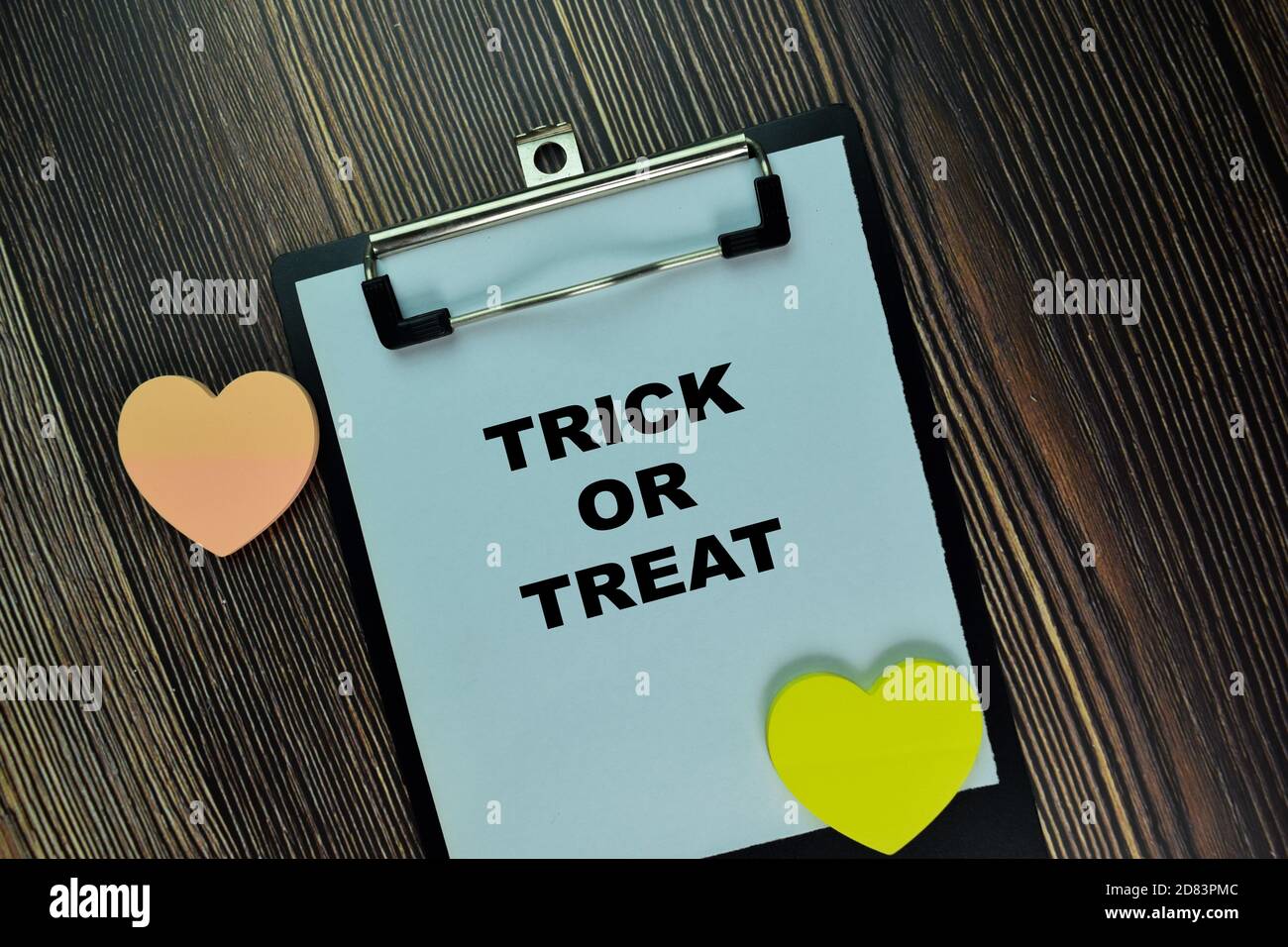 Trick or Treat write on a paperwork isolated on Wooden Table Stock ...