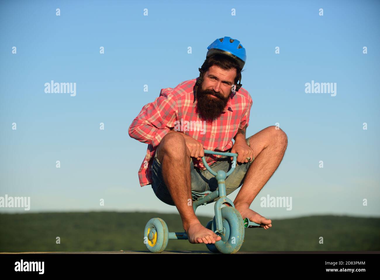 Crazy Young man riding three wheeled bicycle Stock Photo - Alamy