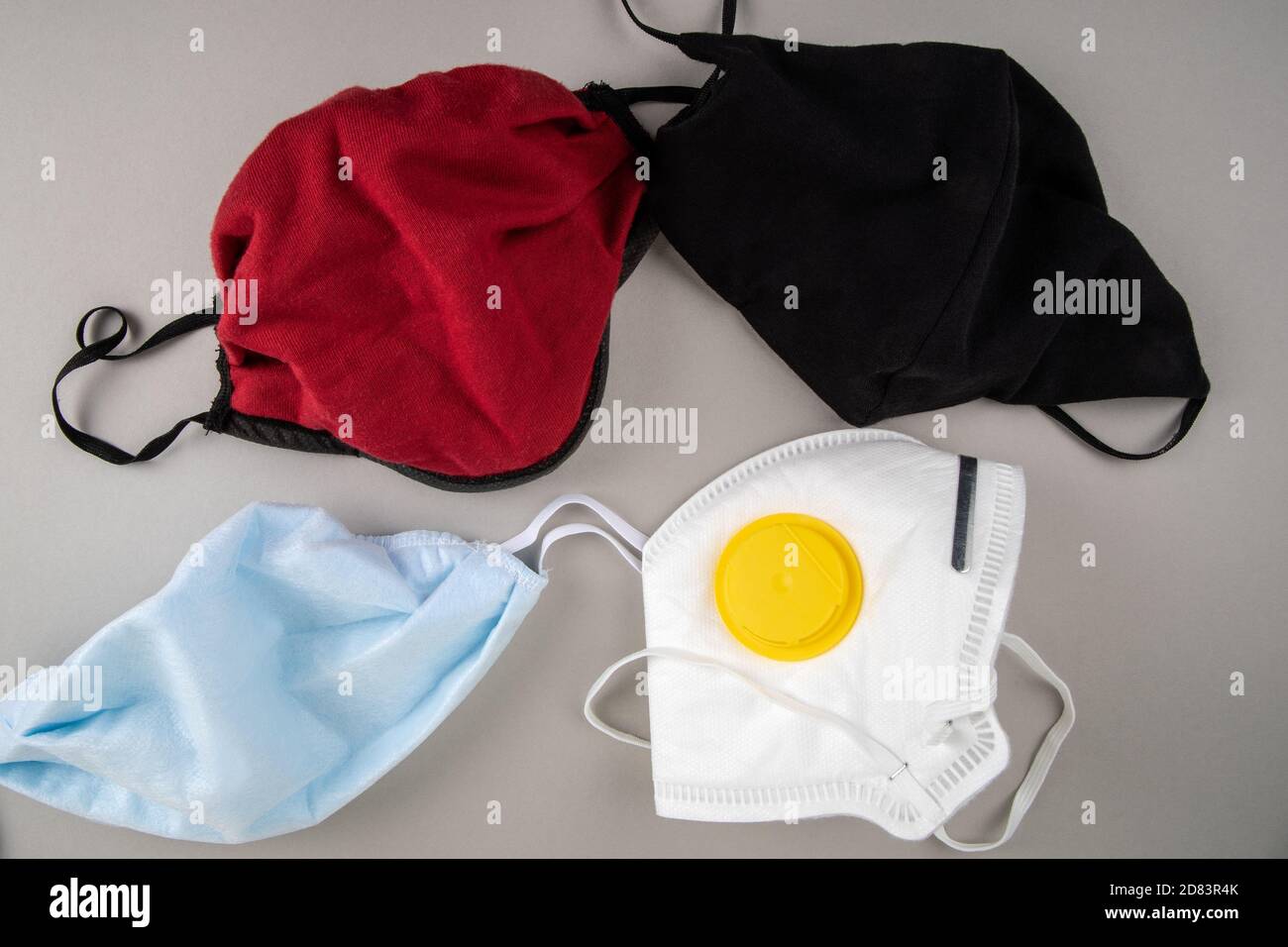Different color face masks on a gray background. Virus spread ...