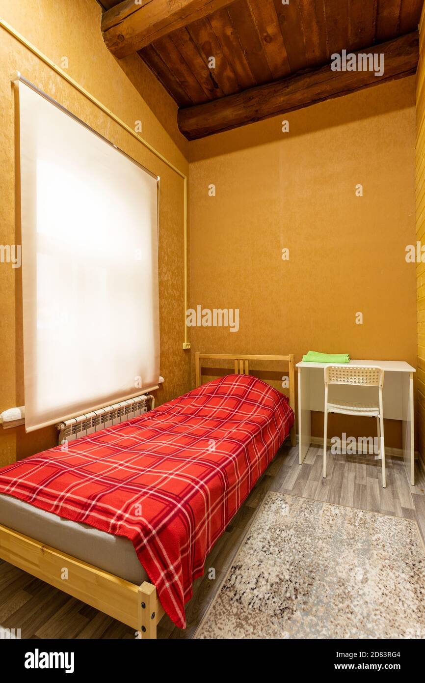 Wooden bed with , desk and chair in hostel room Stock Photo - Alamy