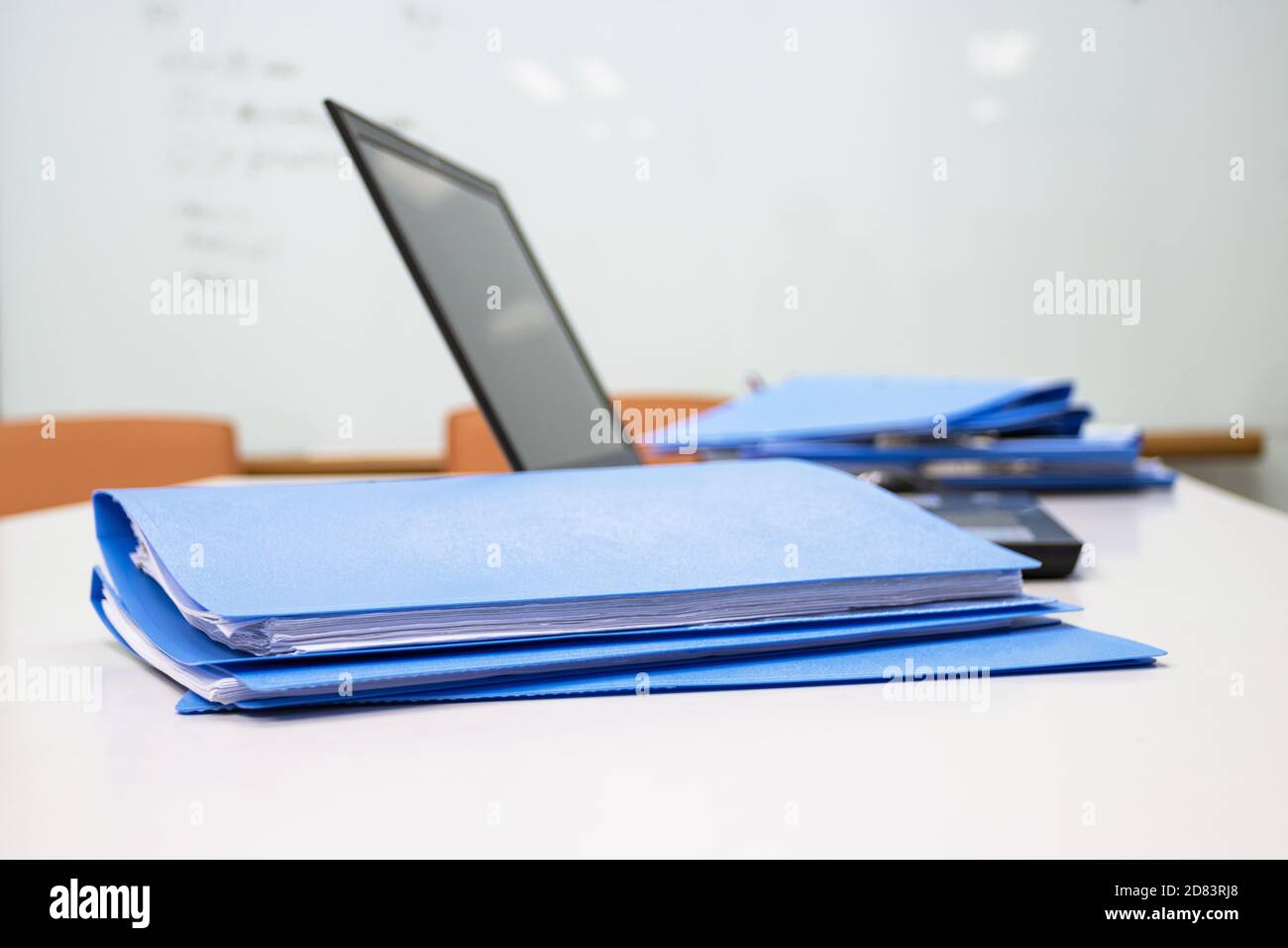 Blue Document folder on table at office with laptop background Stock ...