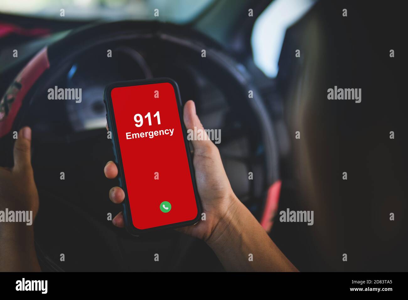 Hand holding cell phone with emergency number 911 in car Stock Photo ...