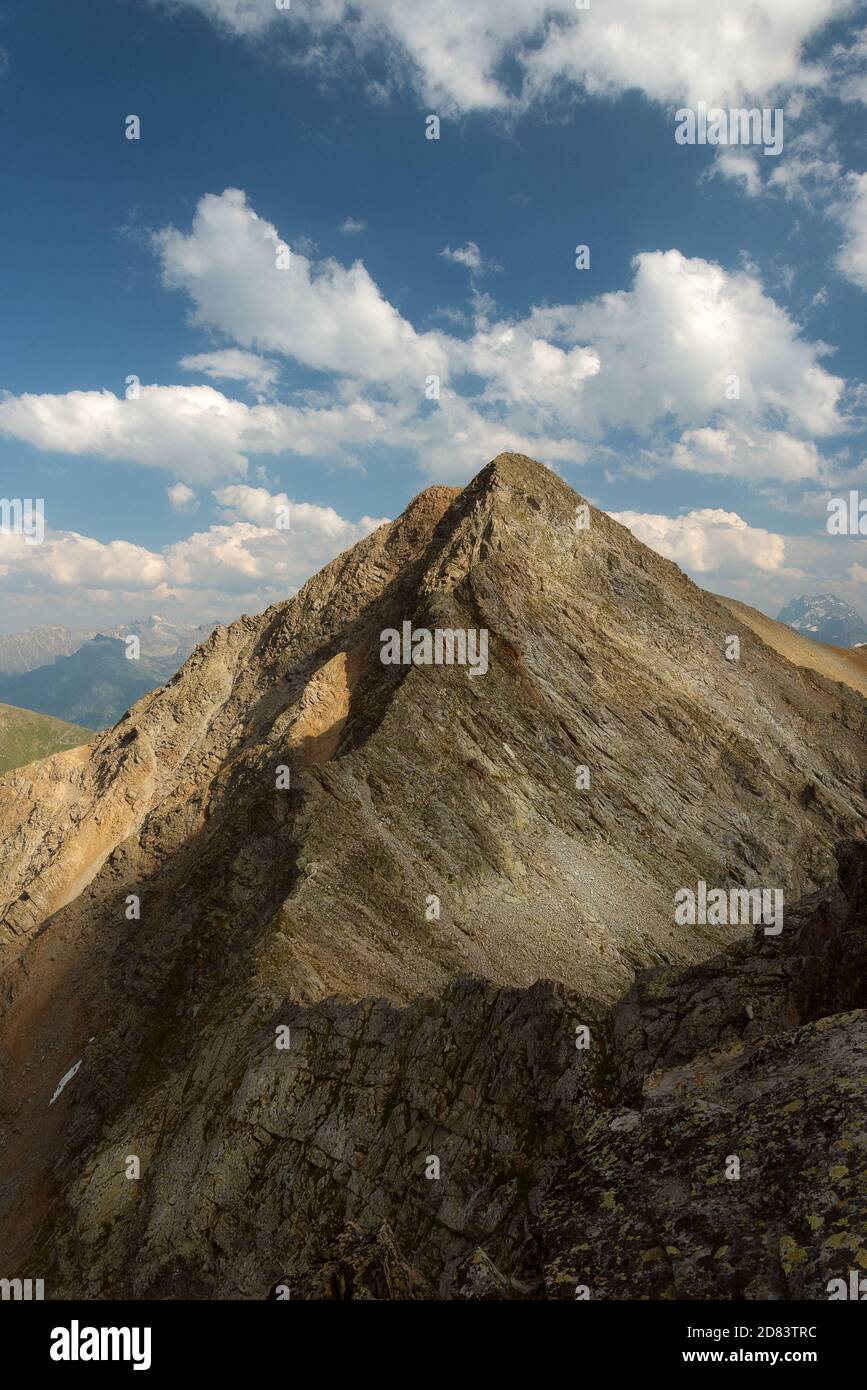 the top of the mountain range against a blue sky with clouds Stock ...