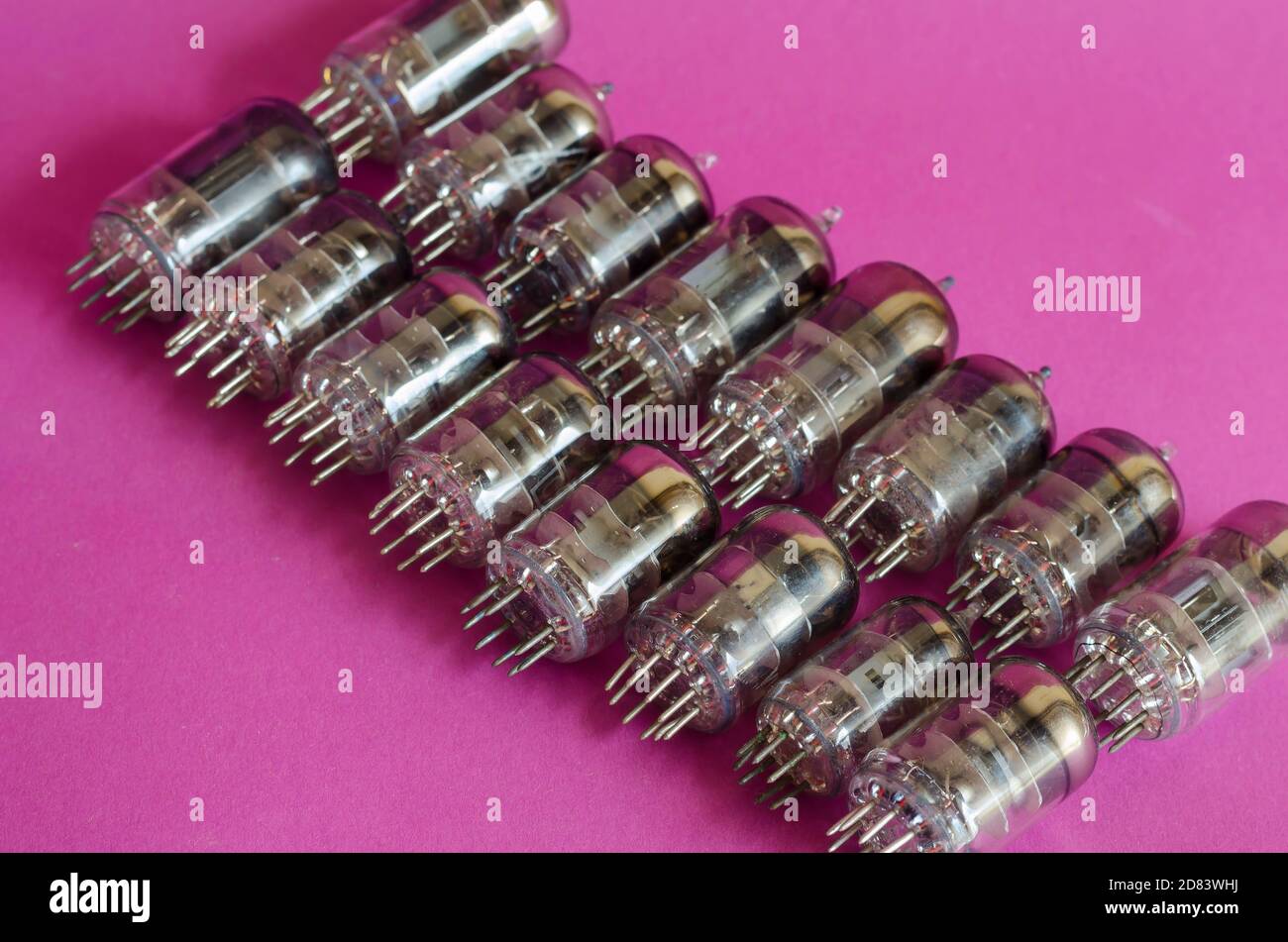 Group of random radio tubes on a pink background. Vacuum tubes of ...
