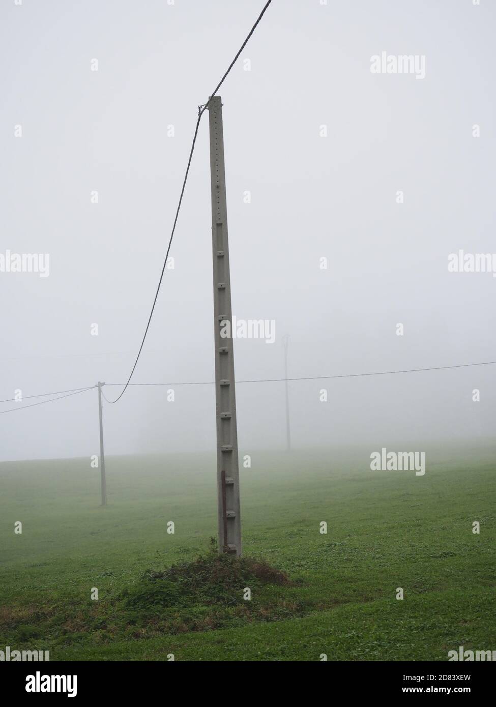 old electricity pole on a cloudy background Stock Photo - Alamy