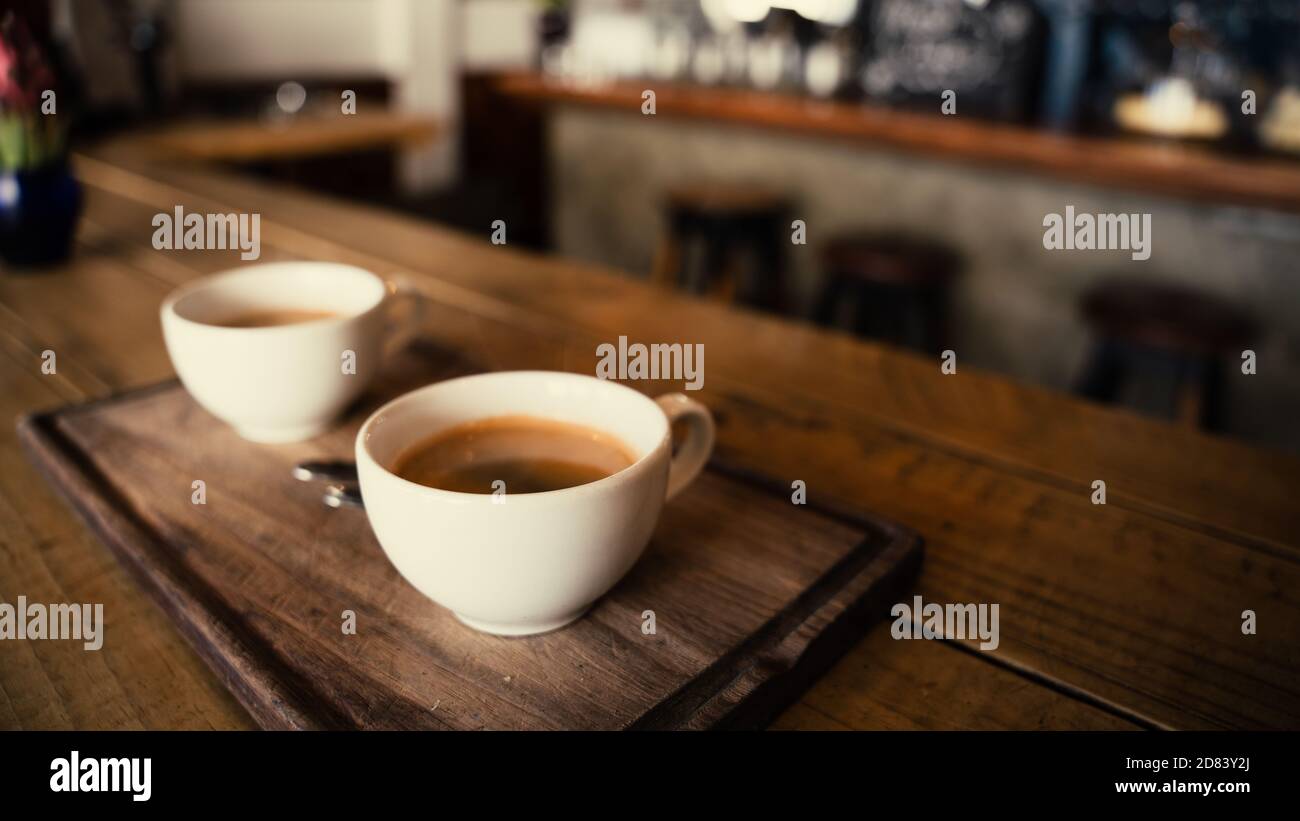close up of two freshly made coffees in big ceramic mugs Stock Photo ...