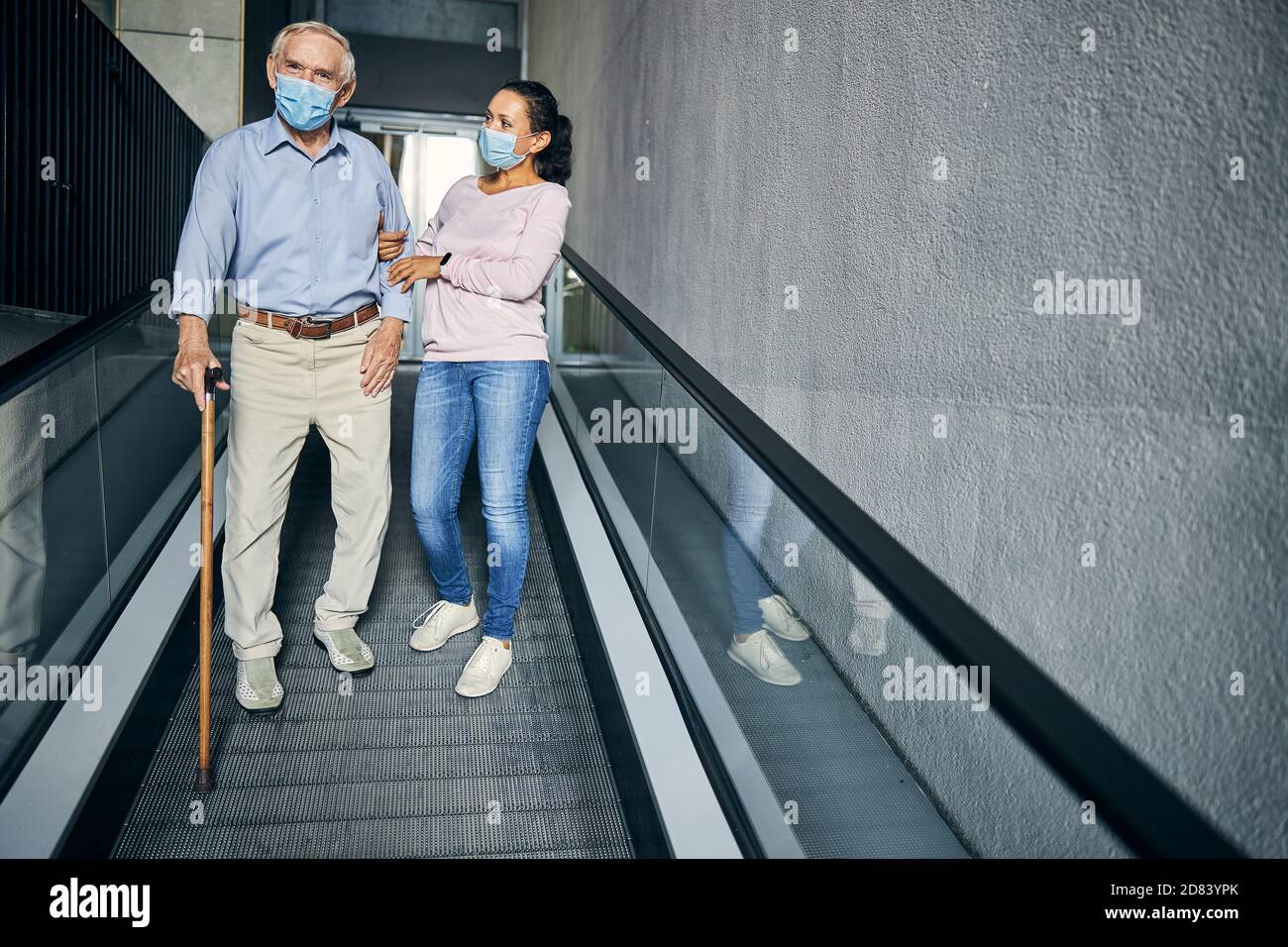 Invalid old man needing support when going with cane Stock Photo - Alamy