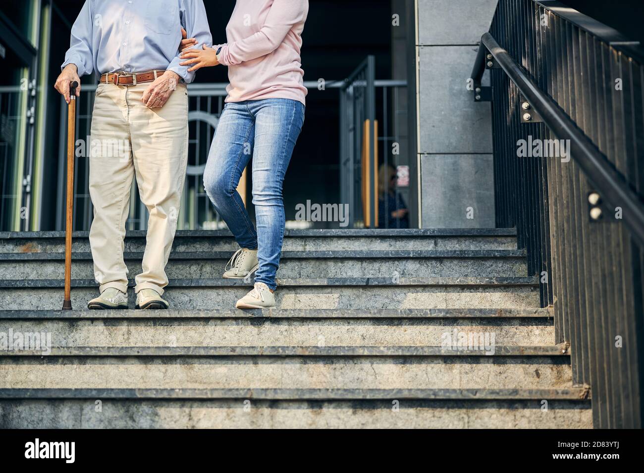Person going down the stairs hi-res stock photography and images - Alamy