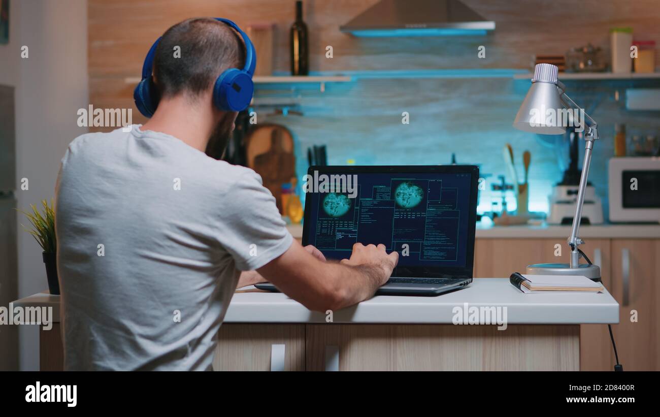 Back view of hacker with headset attacking succesfully the government ...