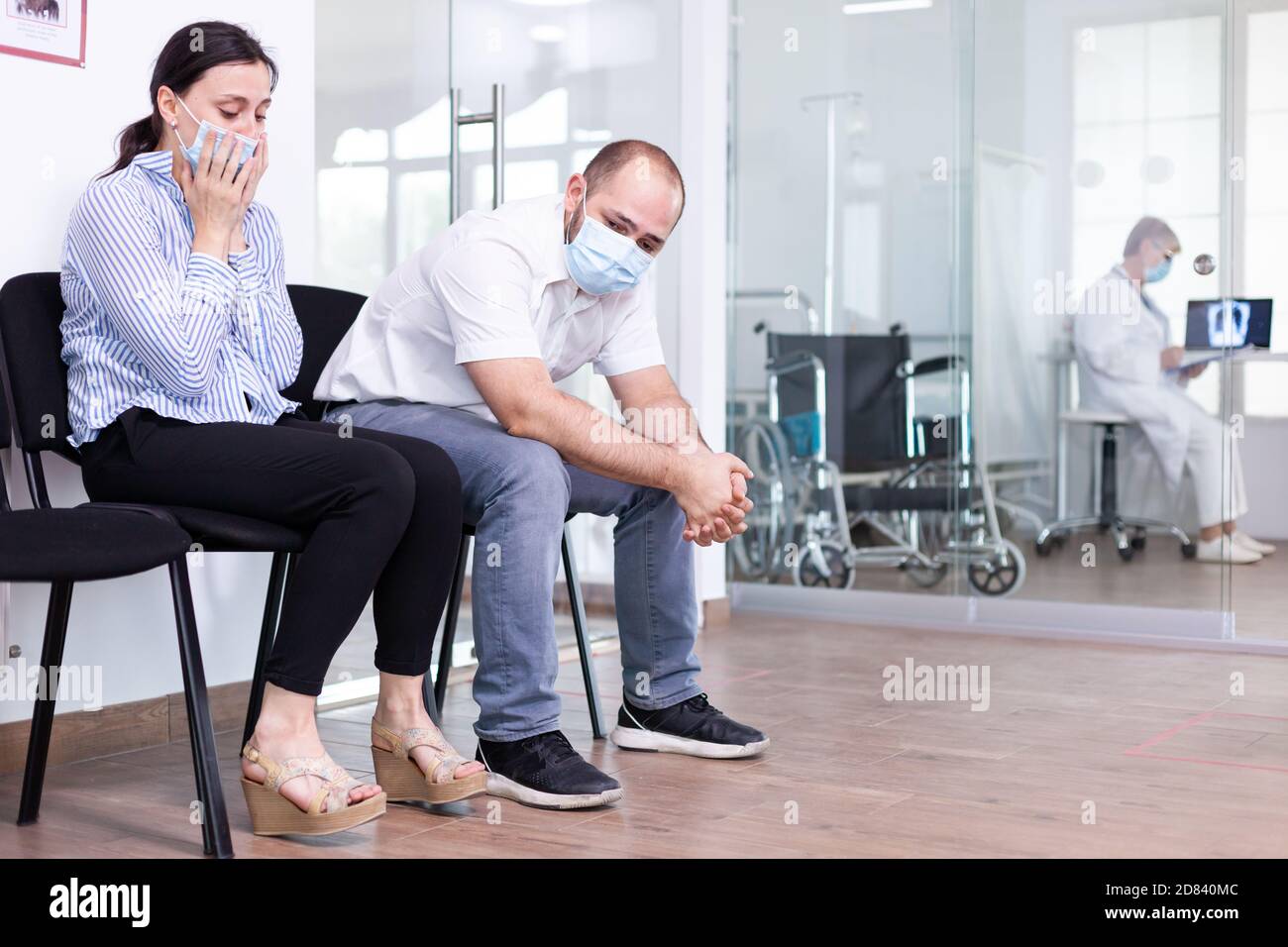 Upset couple in hospital waiting room after bad news from medical stuff ...