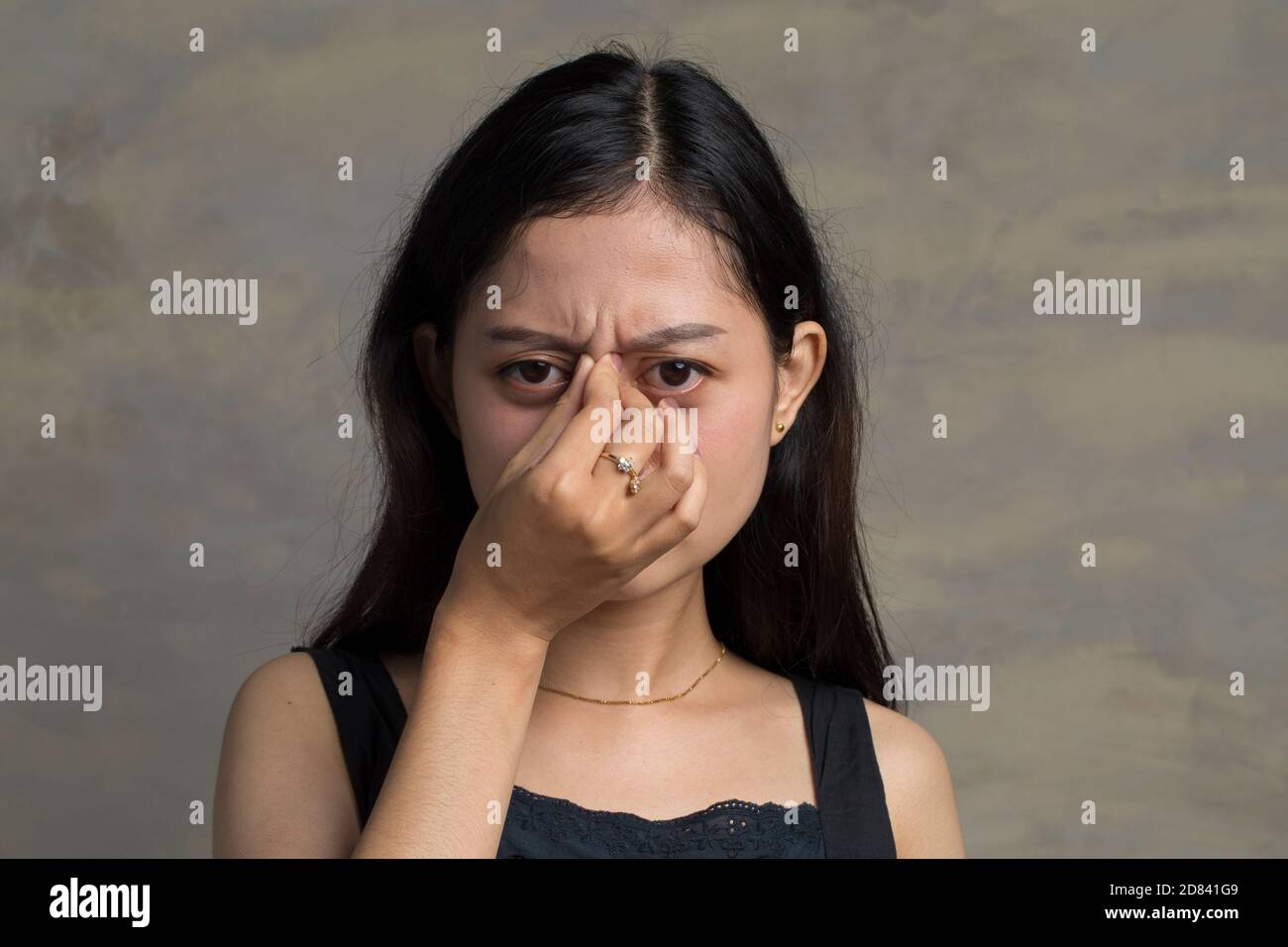 Asian Woman feeling eye pain Stock Photo - Alamy